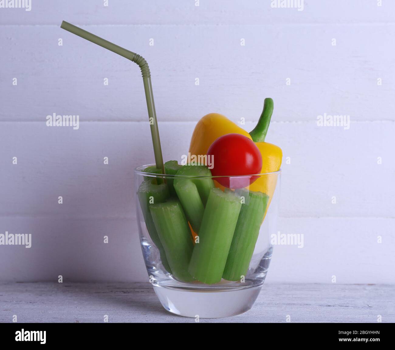 Vegetables in glass with tube on color wooden planks background Stock ...