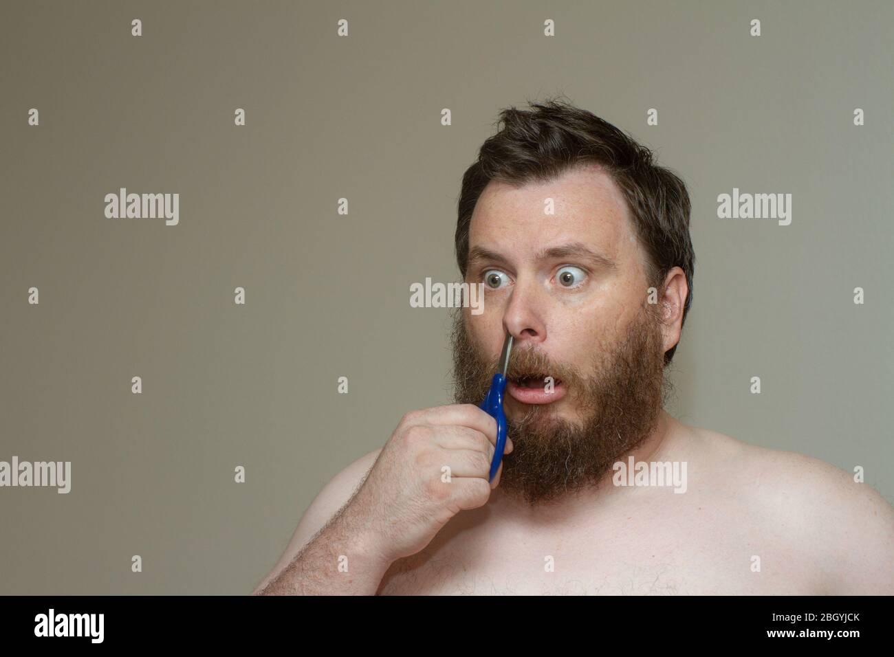 shoving scissors up his nose to try to clean up Stock Photo - Alamy