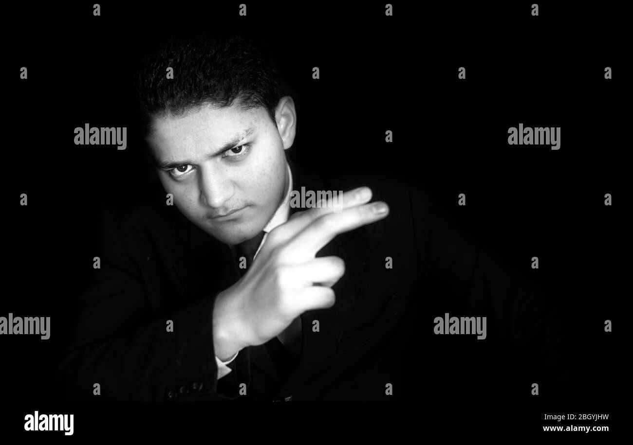 Portrait shot of a young rich man in a blue suit and holding something ...