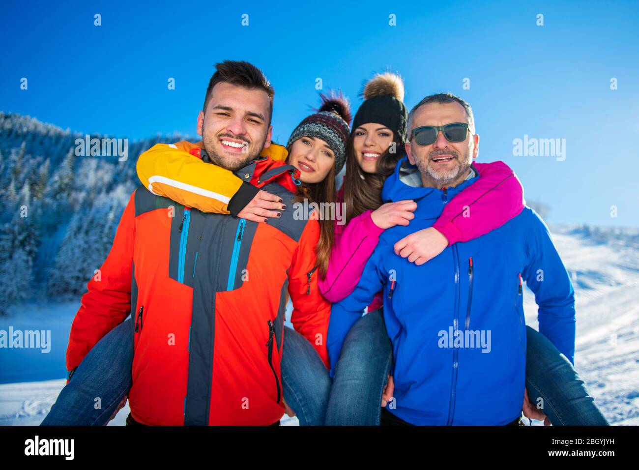 Friends Have Fun At Winter On Fresh Snow Stock Photo - Alamy