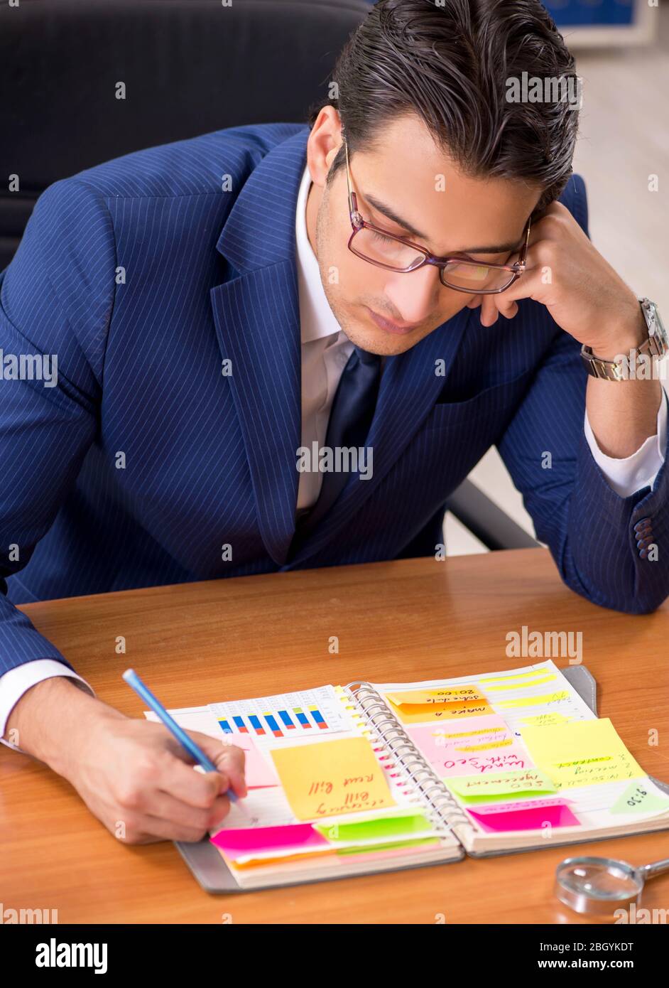 The young handsome employee planning his work activity Stock Photo - Alamy