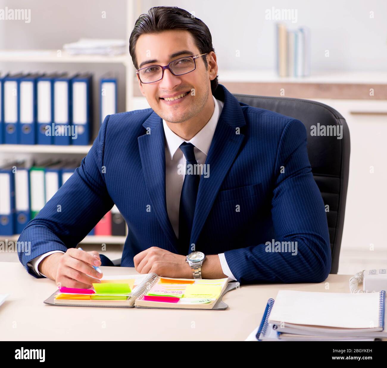 The young handsome employee planning his work activity Stock Photo - Alamy