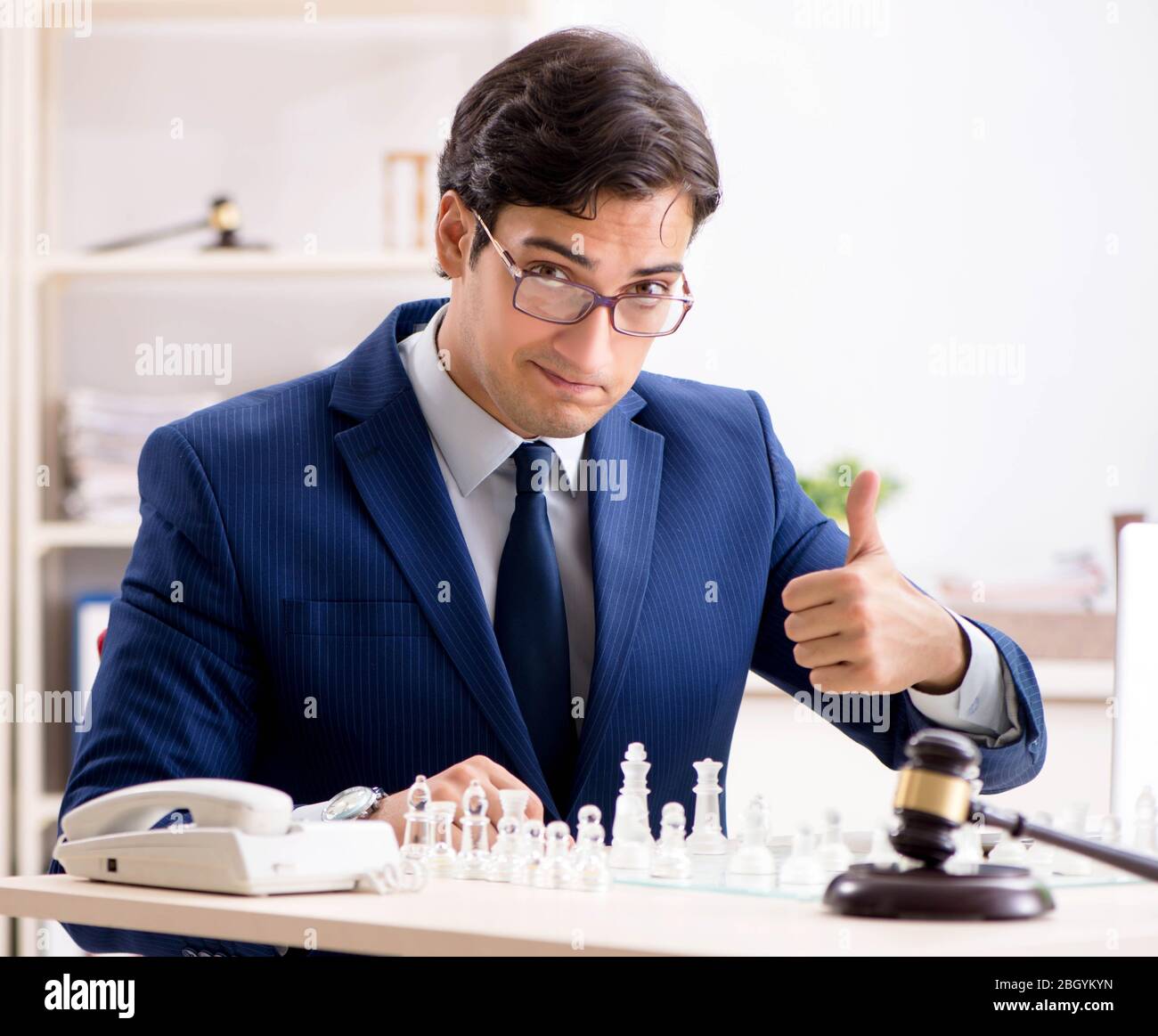 Young lawyer playing chess to train his court strategy and tactics ...