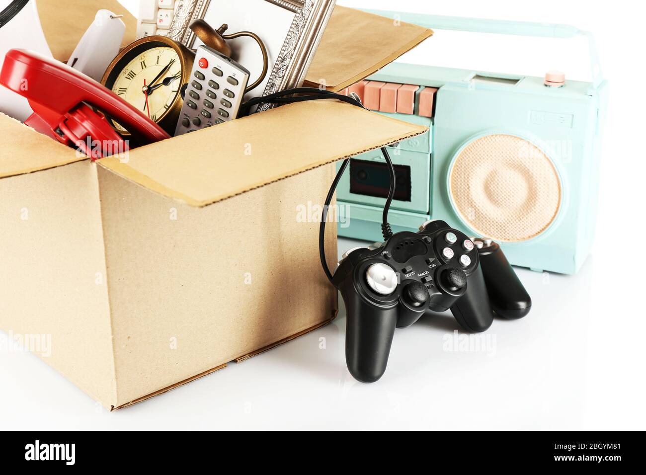 Box of unwanted stuff isolated on white Stock Photo - Alamy