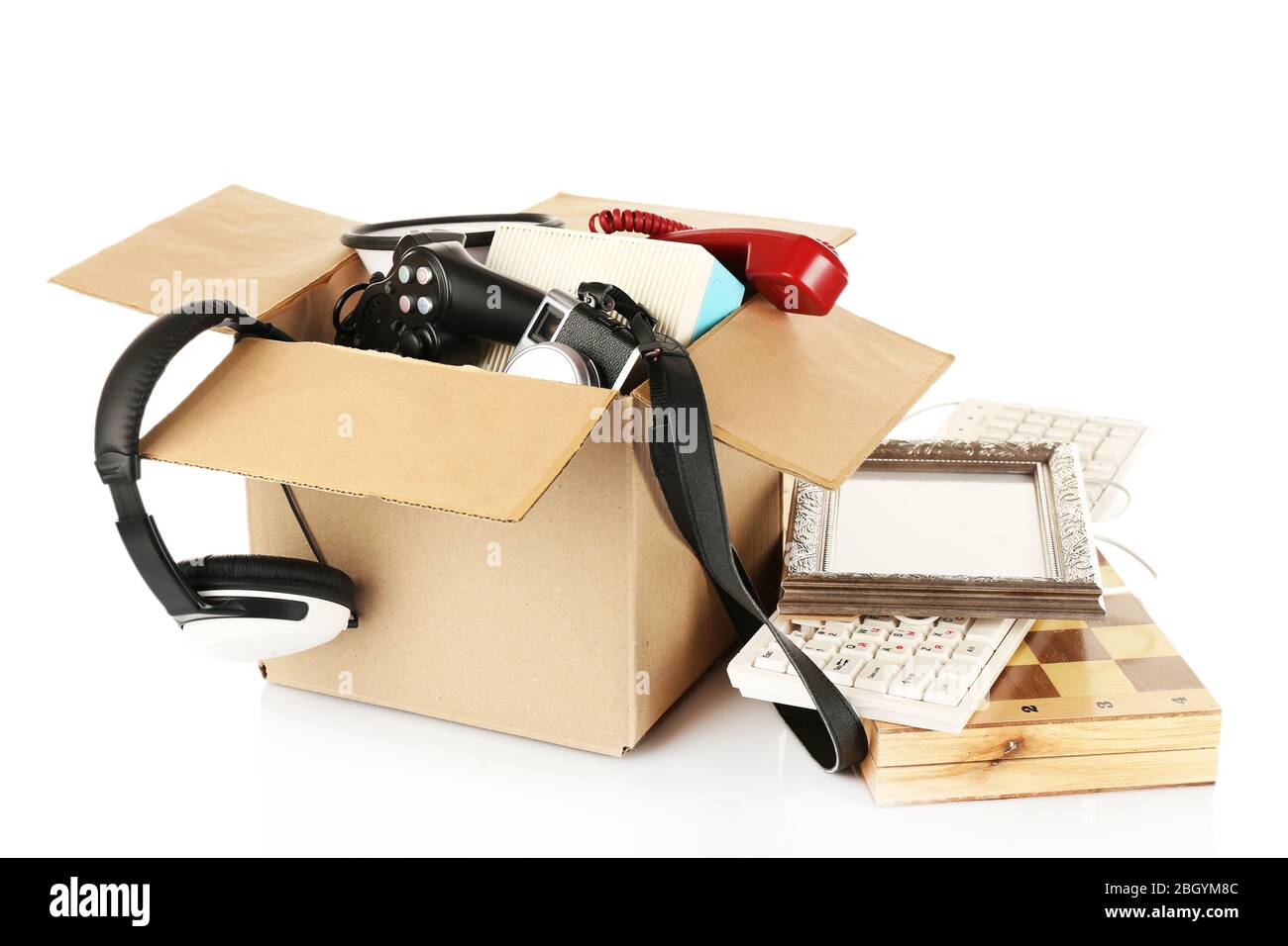 Box of unwanted stuff isolated on white Stock Photo - Alamy