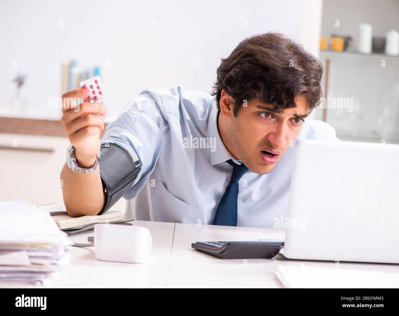 The man under stress measuring his blood pressure Stock Photo - Alamy