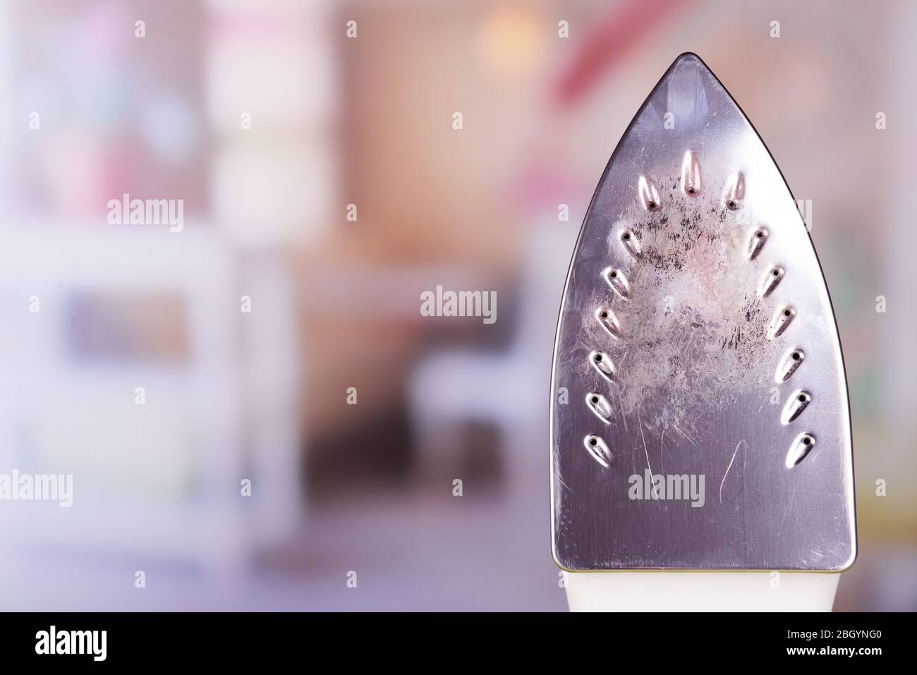 Flat iron with burnt mark on bright background Stock Photo - Alamy