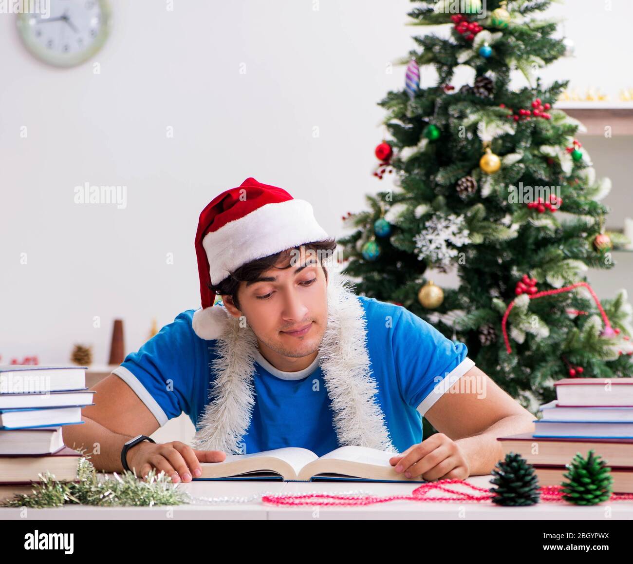 The young student with book at christmas eve Stock Photo - Alamy