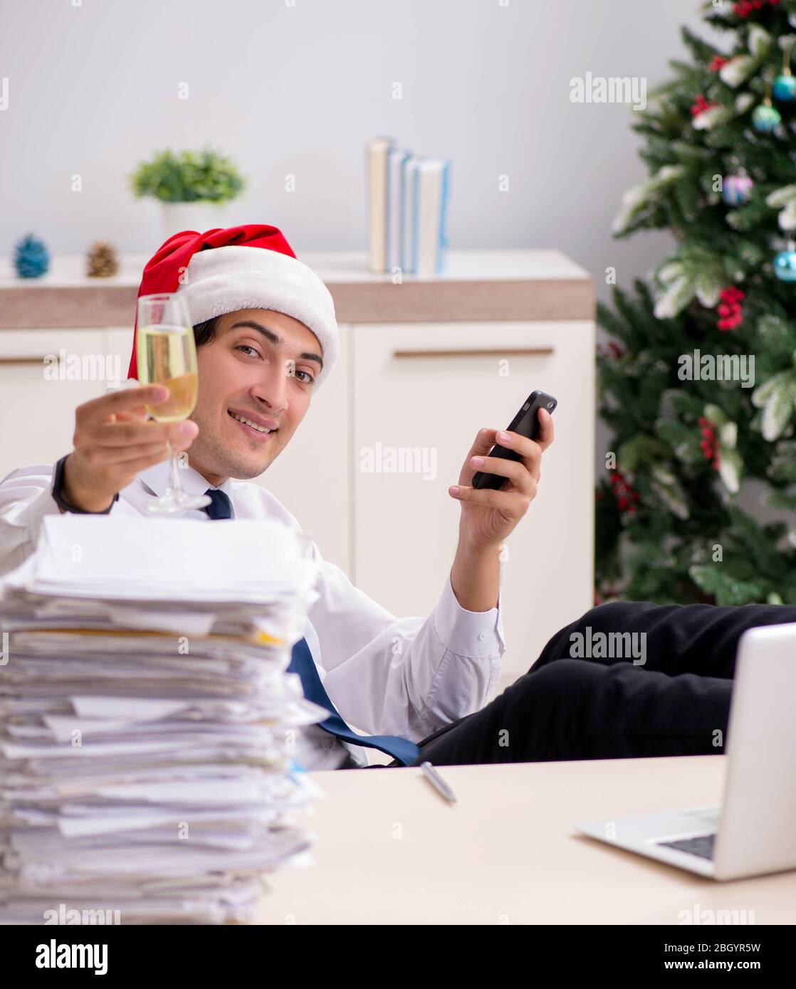 The young worker working in office on christmas shift Stock Photo - Alamy