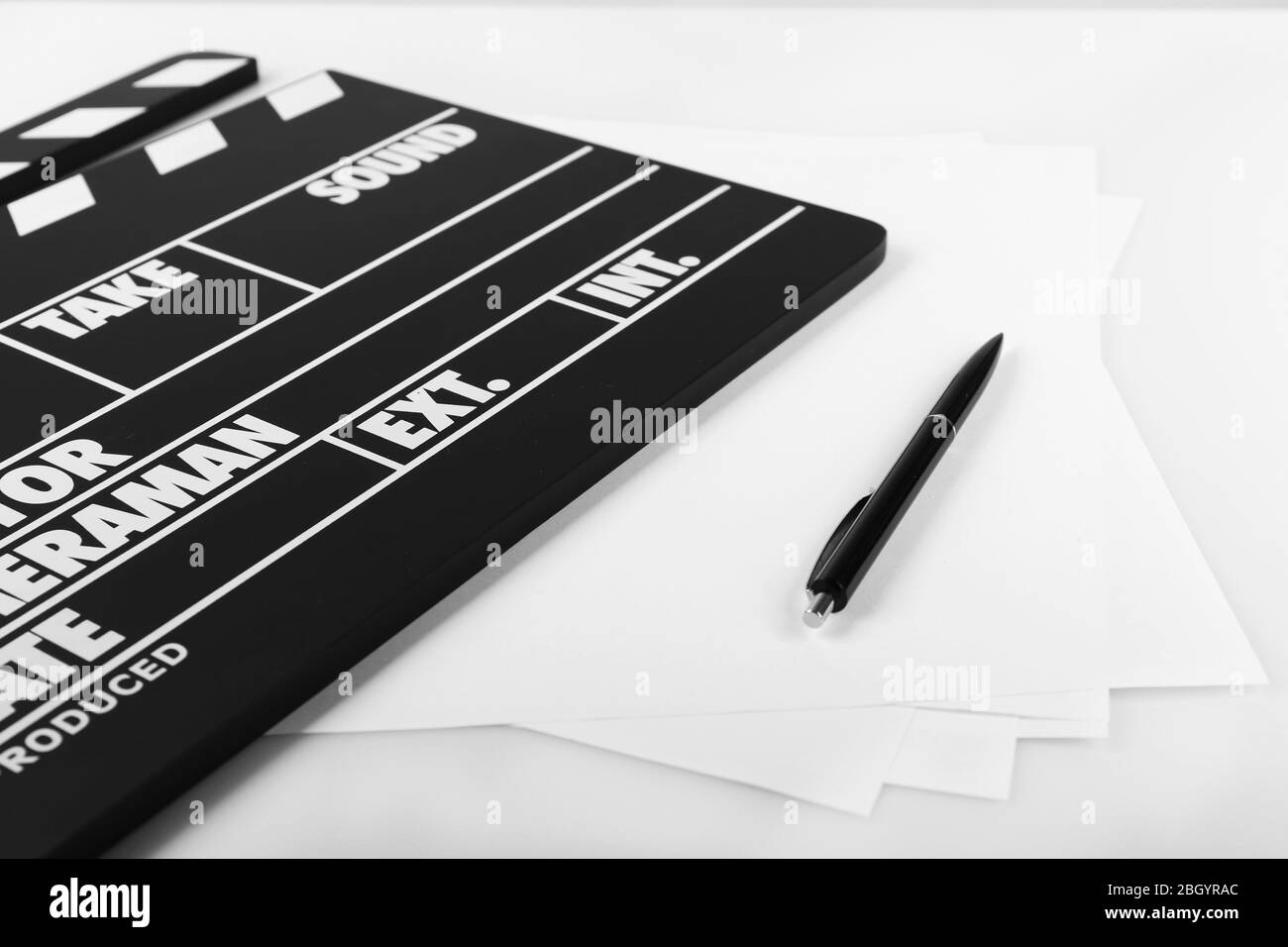 Movie clapper with sheets of paper and pen on white background Stock ...
