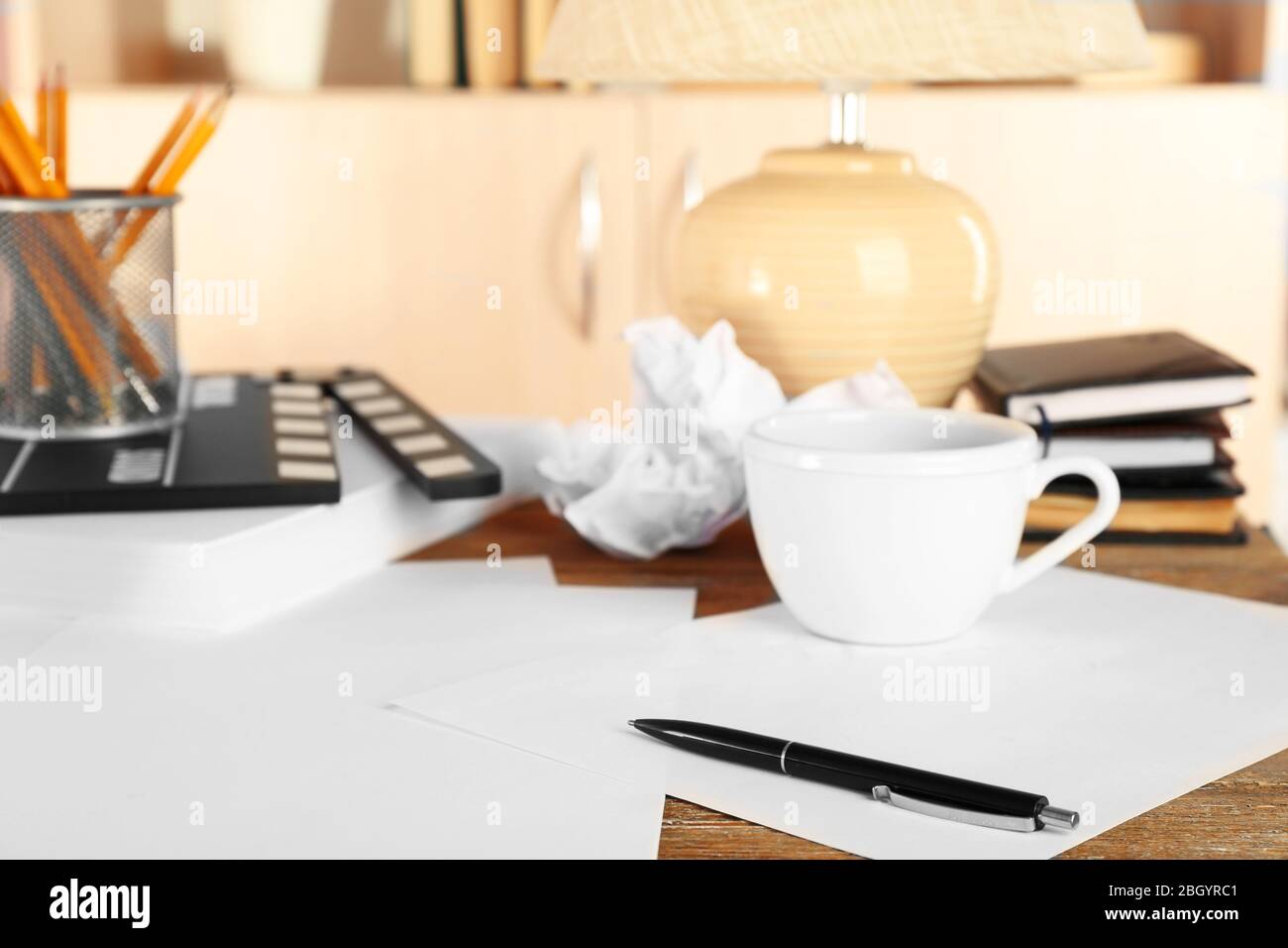 Desktop with moving clapper and working mess on light cupboard ...