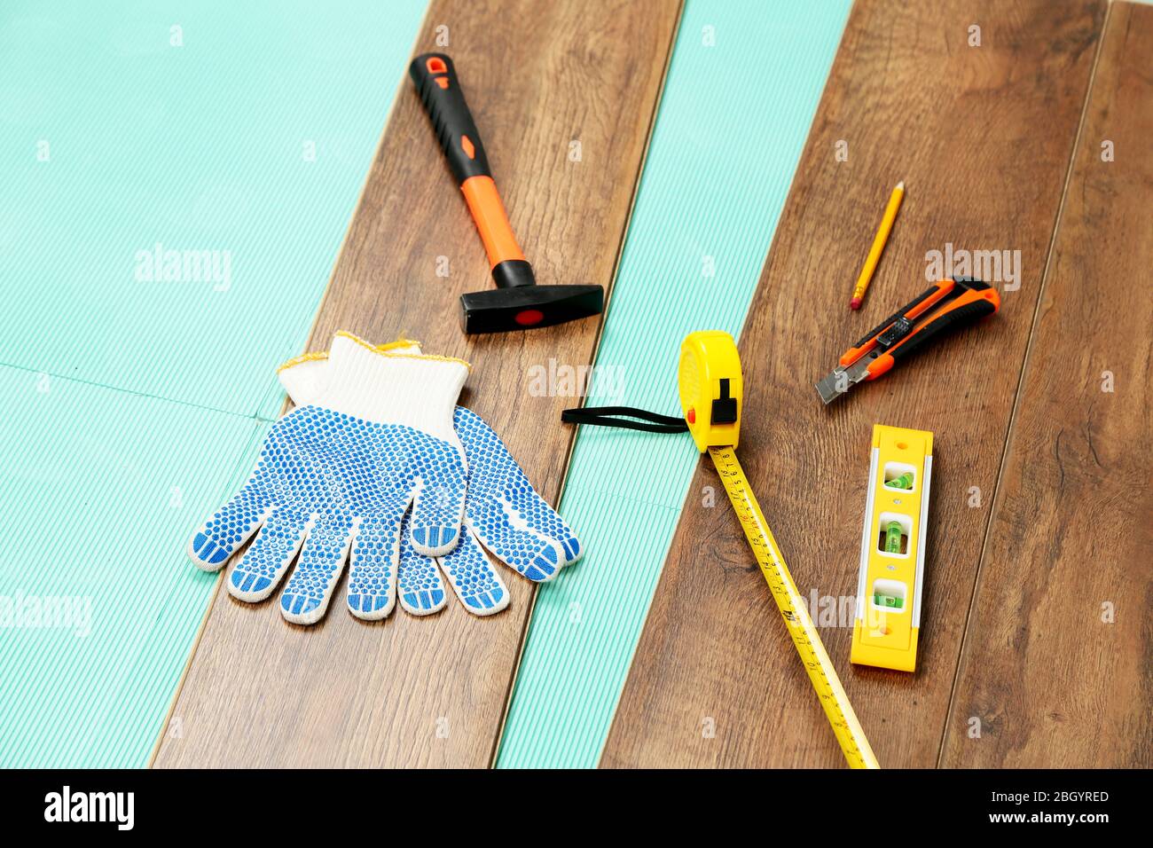 Carpenter tools on new laminate floor Stock Photo - Alamy