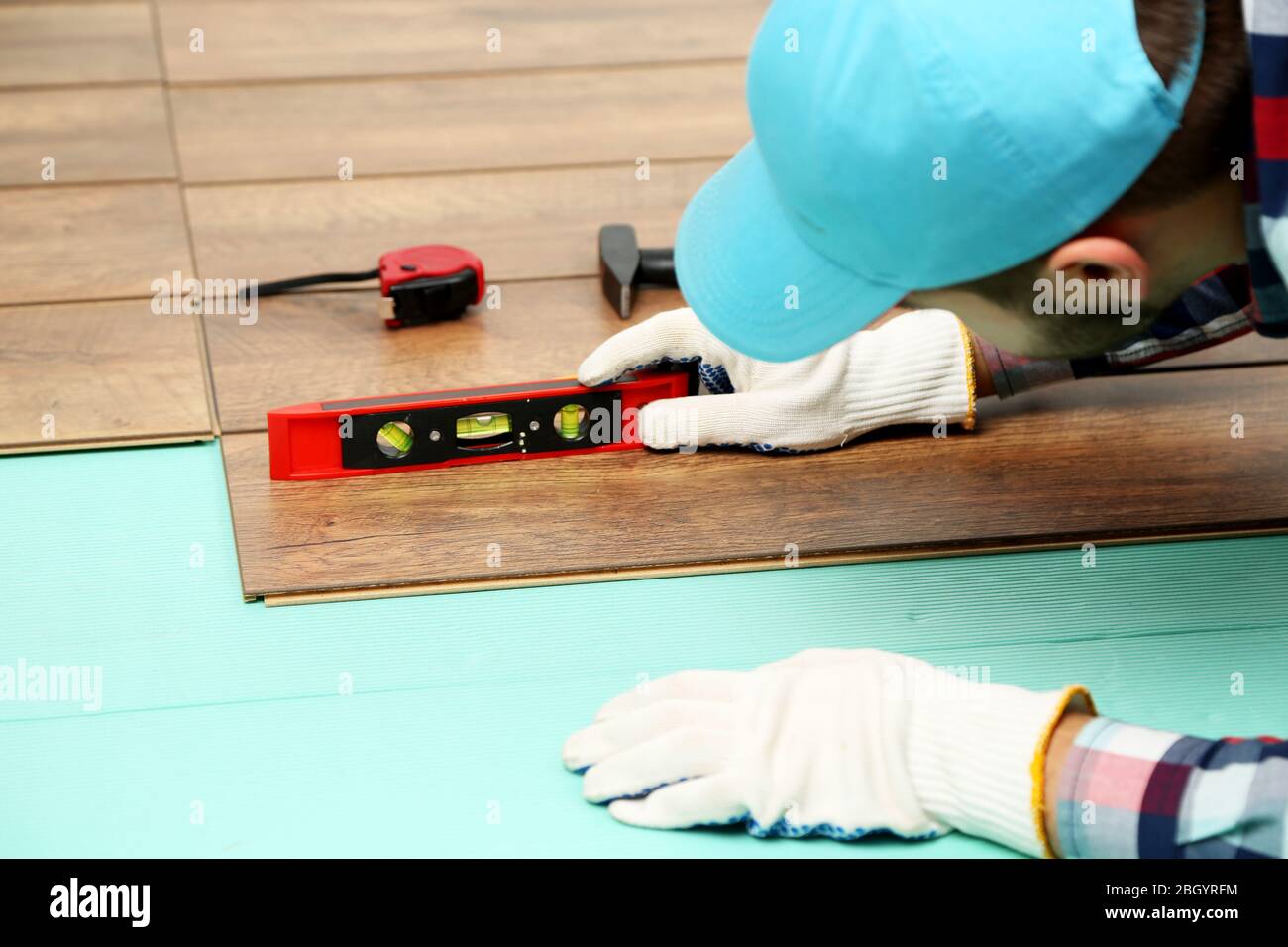 Carpenter worker installing laminate flooring in the room Stock Photo ...
