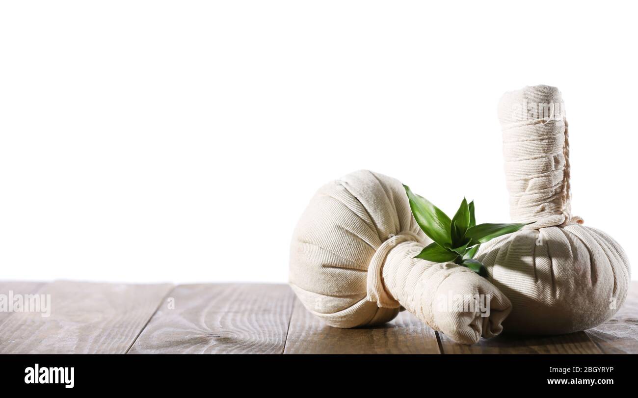 Spa compress balls with green leaves isolated on white Stock Photo - Alamy