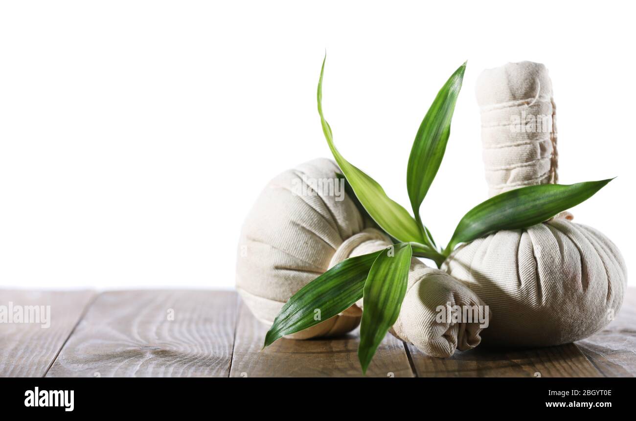 Spa compress balls with green leaves isolated on white Stock Photo - Alamy