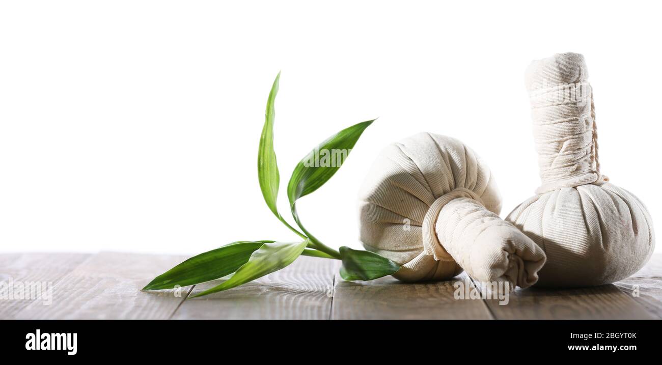 Spa compress balls with green leaves isolated on white Stock Photo - Alamy