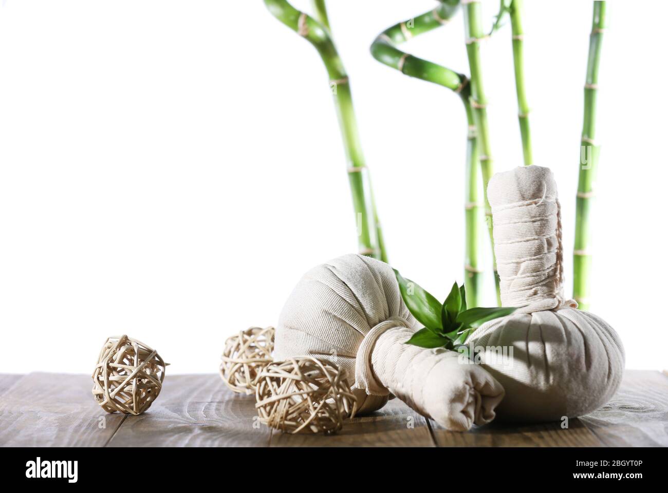 Spa compress balls with bamboo sticks isolated on white Stock Photo - Alamy