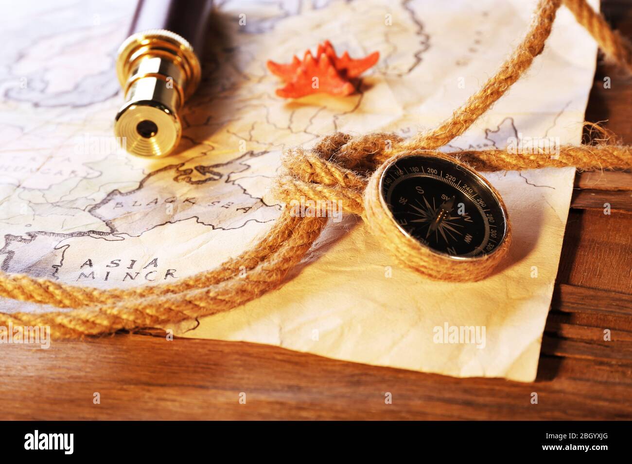 Marine still life with world map on wooden table background Stock Photo ...