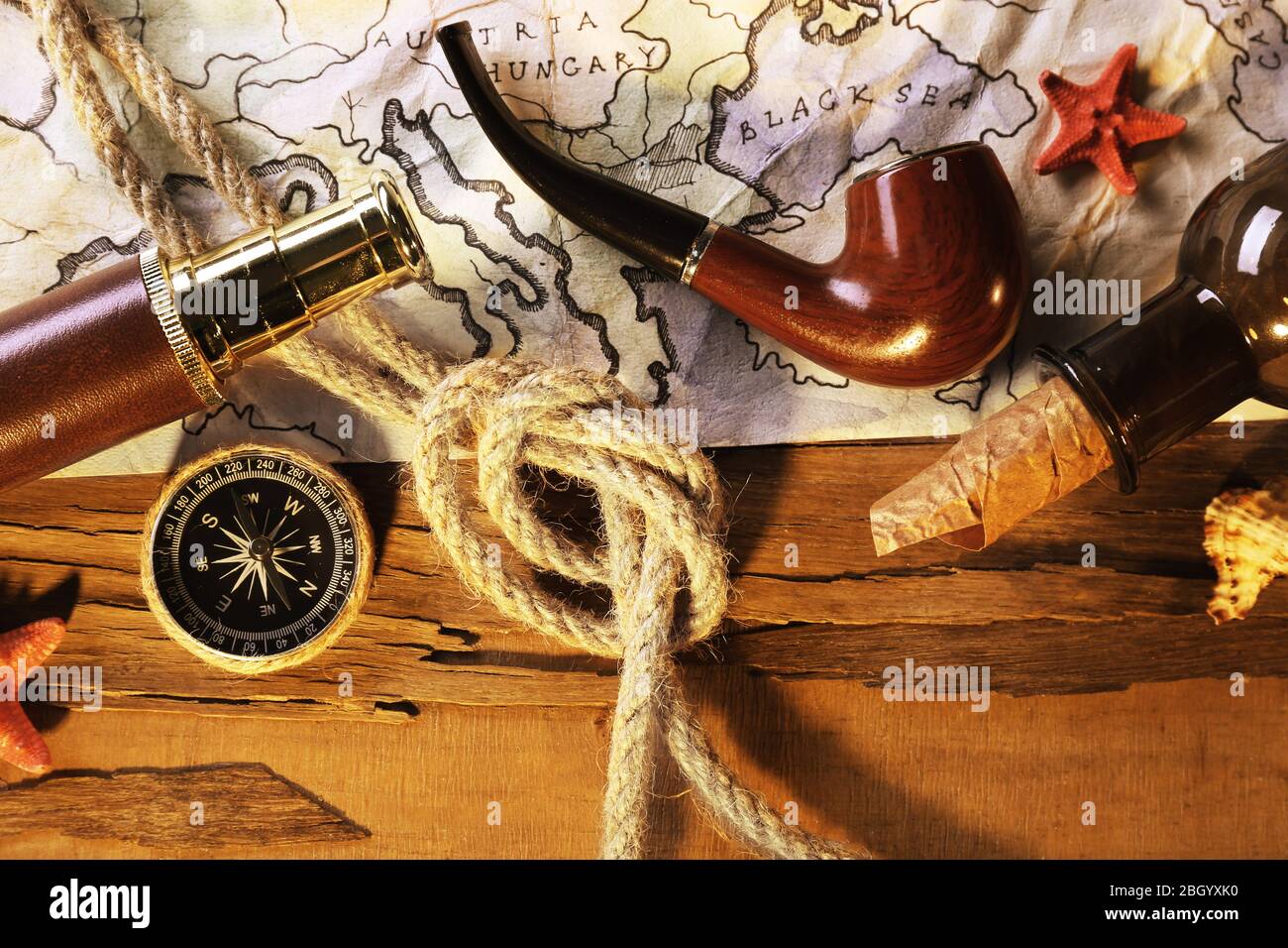 Marine still life with world map and rope on wooden table background ...