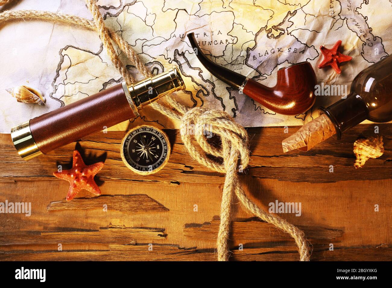 Marine still life with world map and rope on wooden table background ...