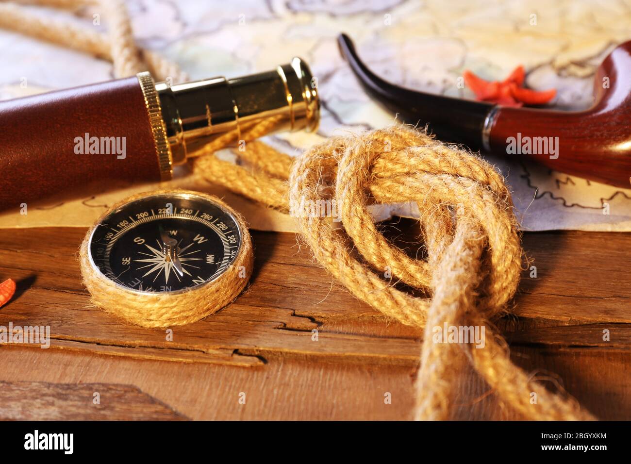 Marine still life with world map and rope on wooden table background ...