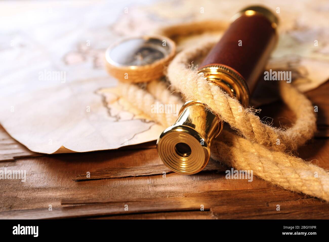 Marine still life spyglass, compass, rope and world map on wooden ...