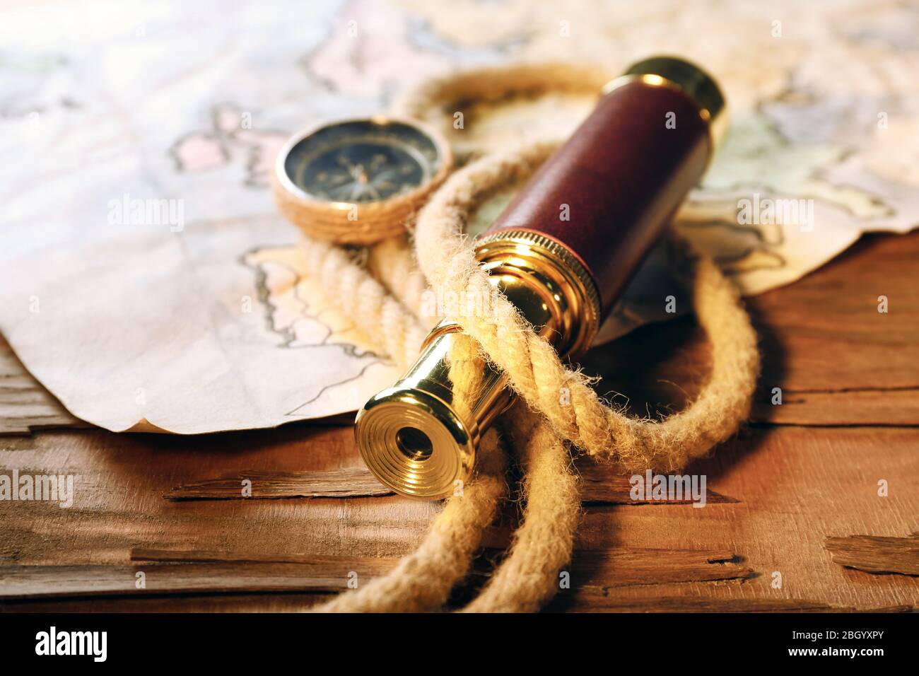 Marine still life spyglass, compass, rope and world map on wooden ...