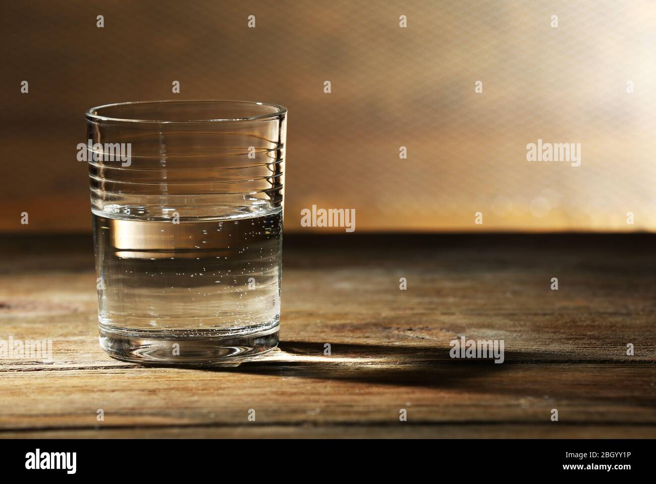 Glass of clean mineral water on surface and background Stock Photo - Alamy