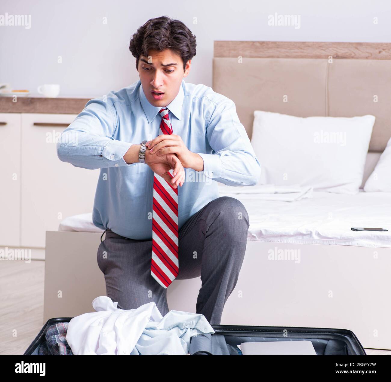 The young handsome businessman preparing for trip Stock Photo - Alamy