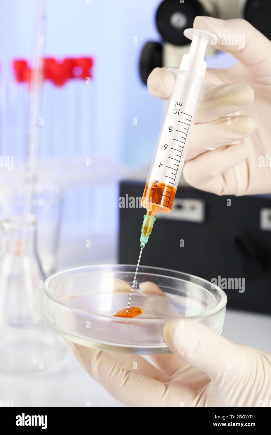 Assistant hands in gloves making analysis in laboratory with microscope ...