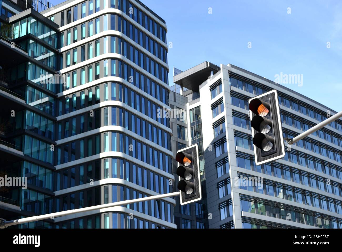 Modern office building, street lights - orange Stock Photo - Alamy