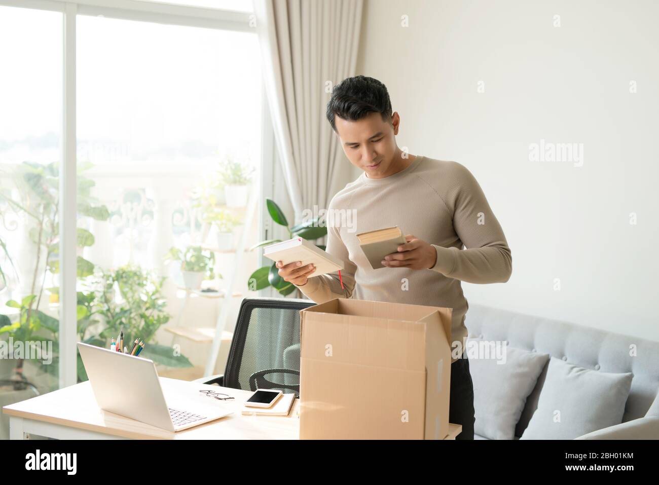 Man opening parcel home hi-res stock photography and images - Alamy
