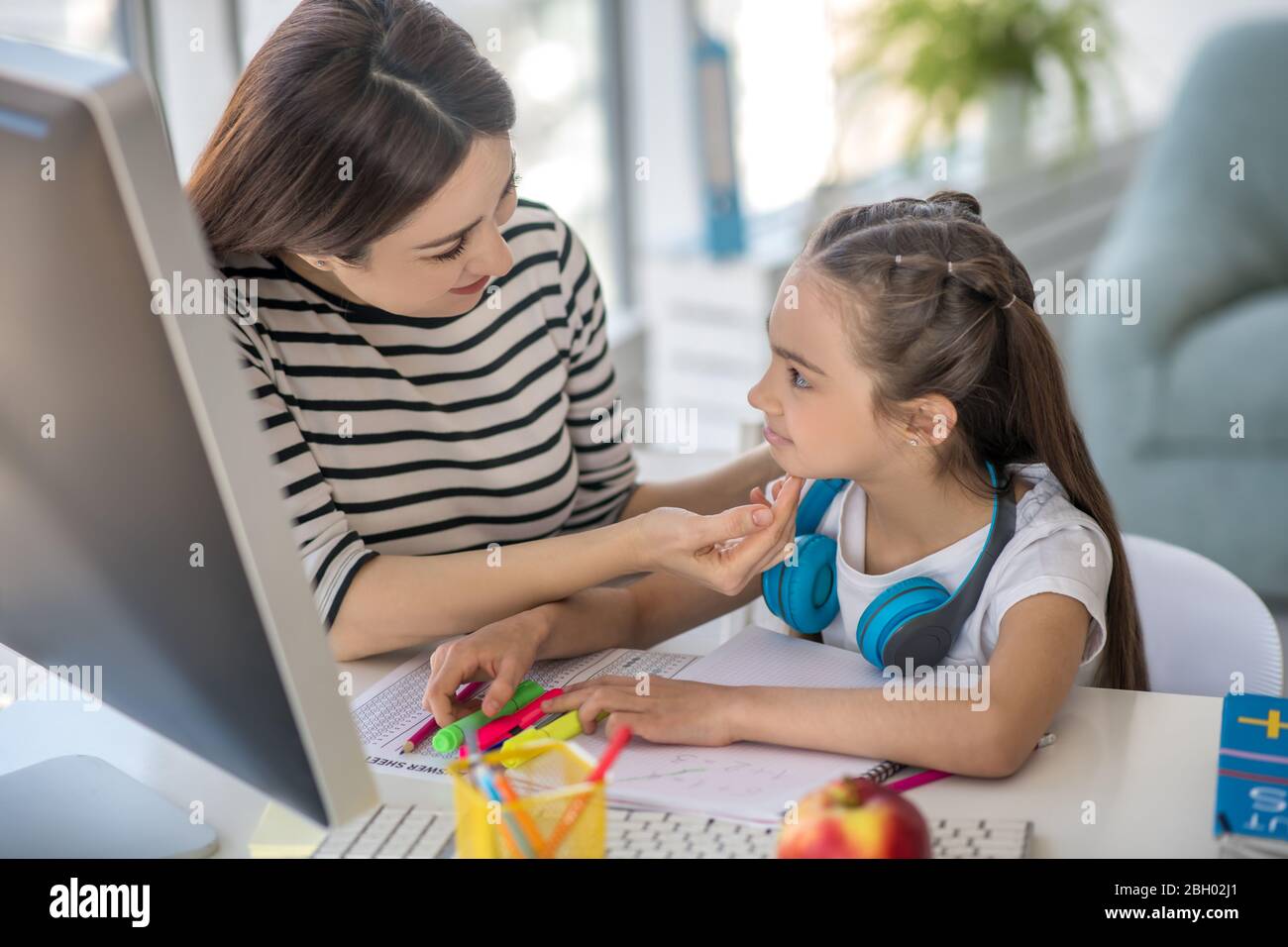 Mom and daughter schoolgirl talking at the table Stock Photo - Alamy