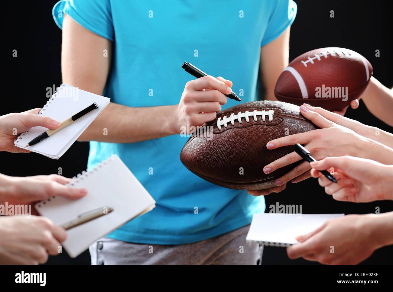 Autographs by American football star on black and lights background ...