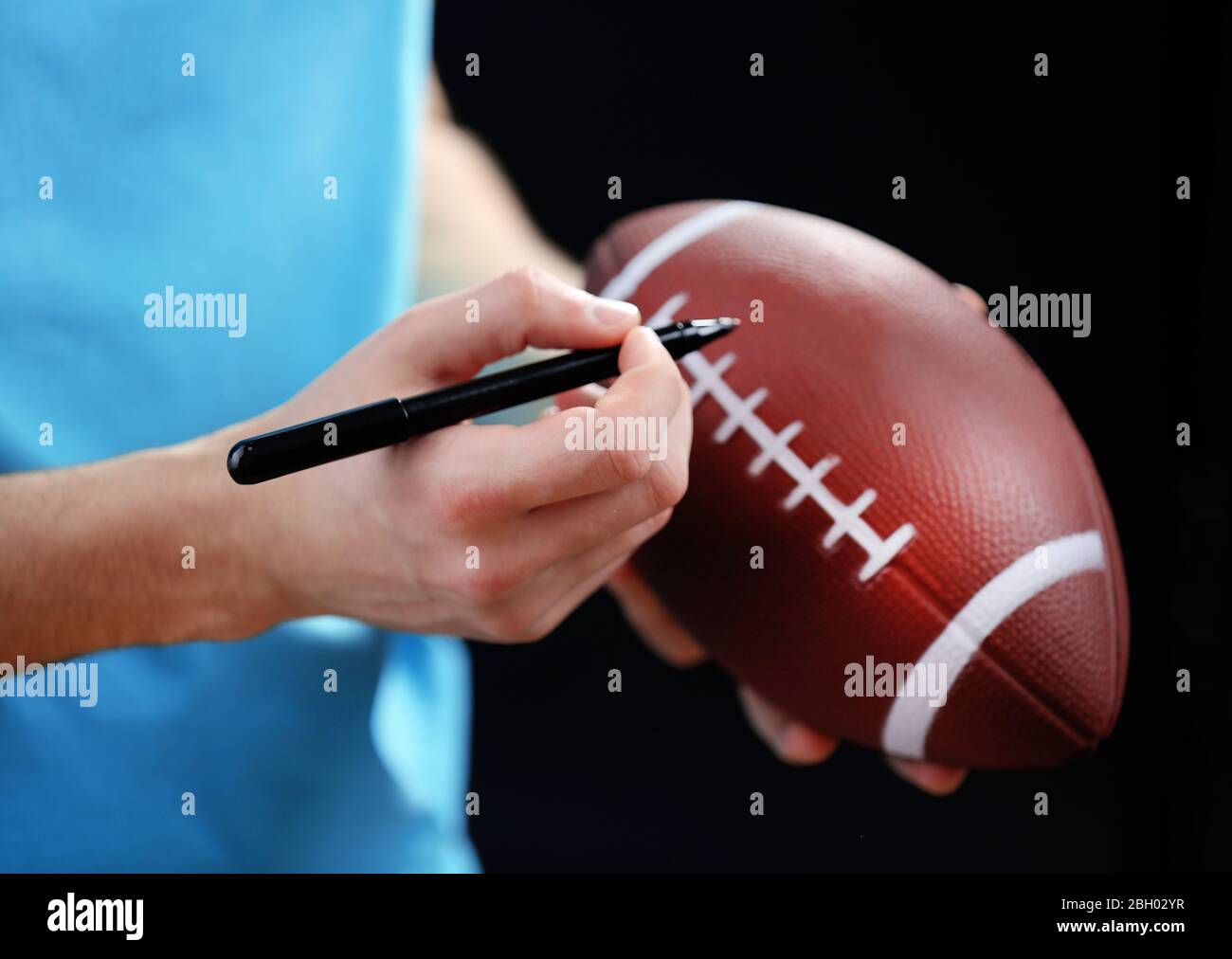 Human hands signing on ball hi-res stock photography and images - Alamy