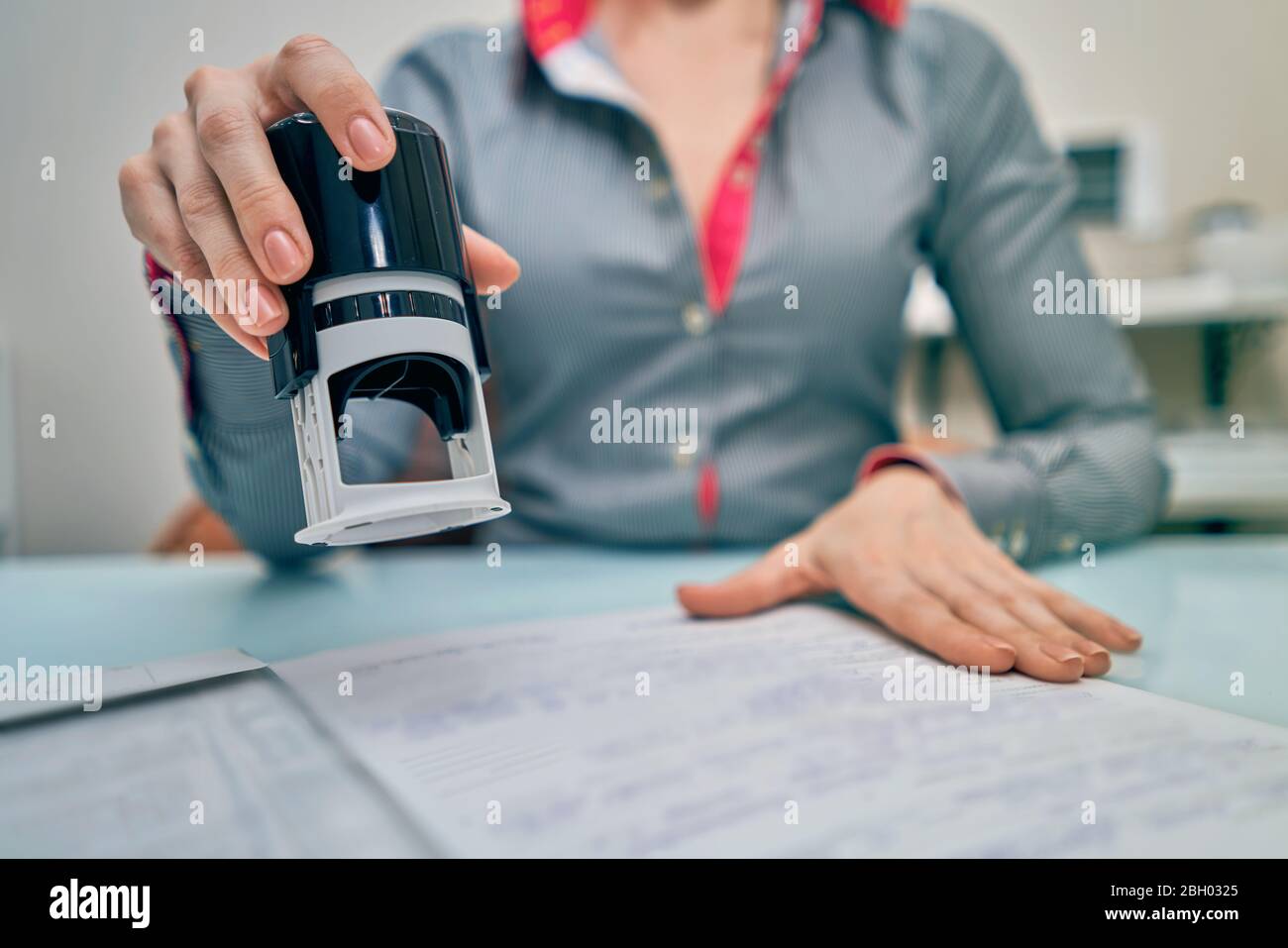 little girl puts a stamp on documents Stock Photo - Alamy