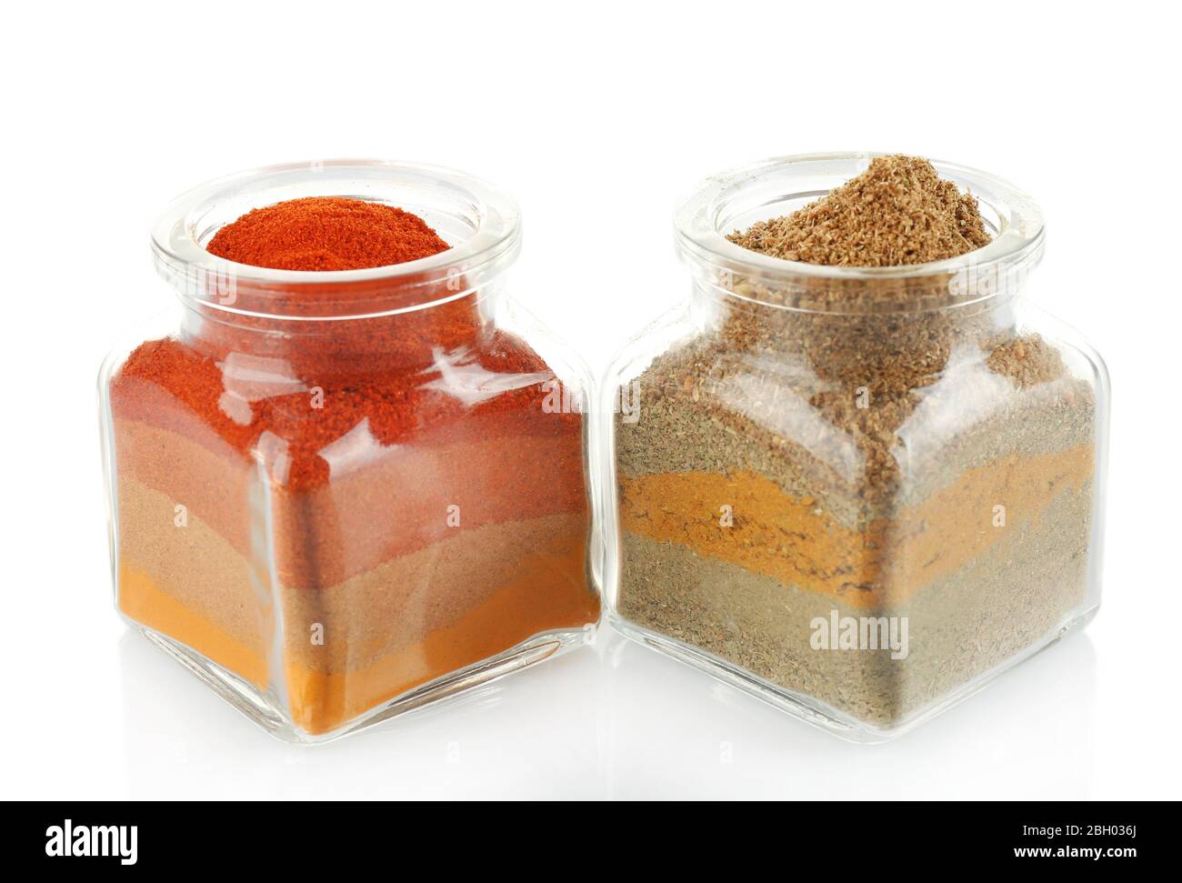 Different kinds of spices in glass bottles isolated on white Stock ...