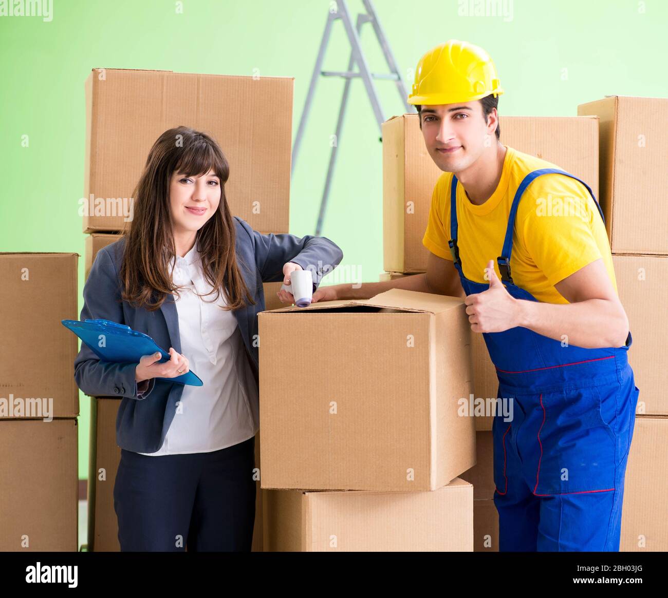The woman boss and man contractor working with boxes delivery Stock ...