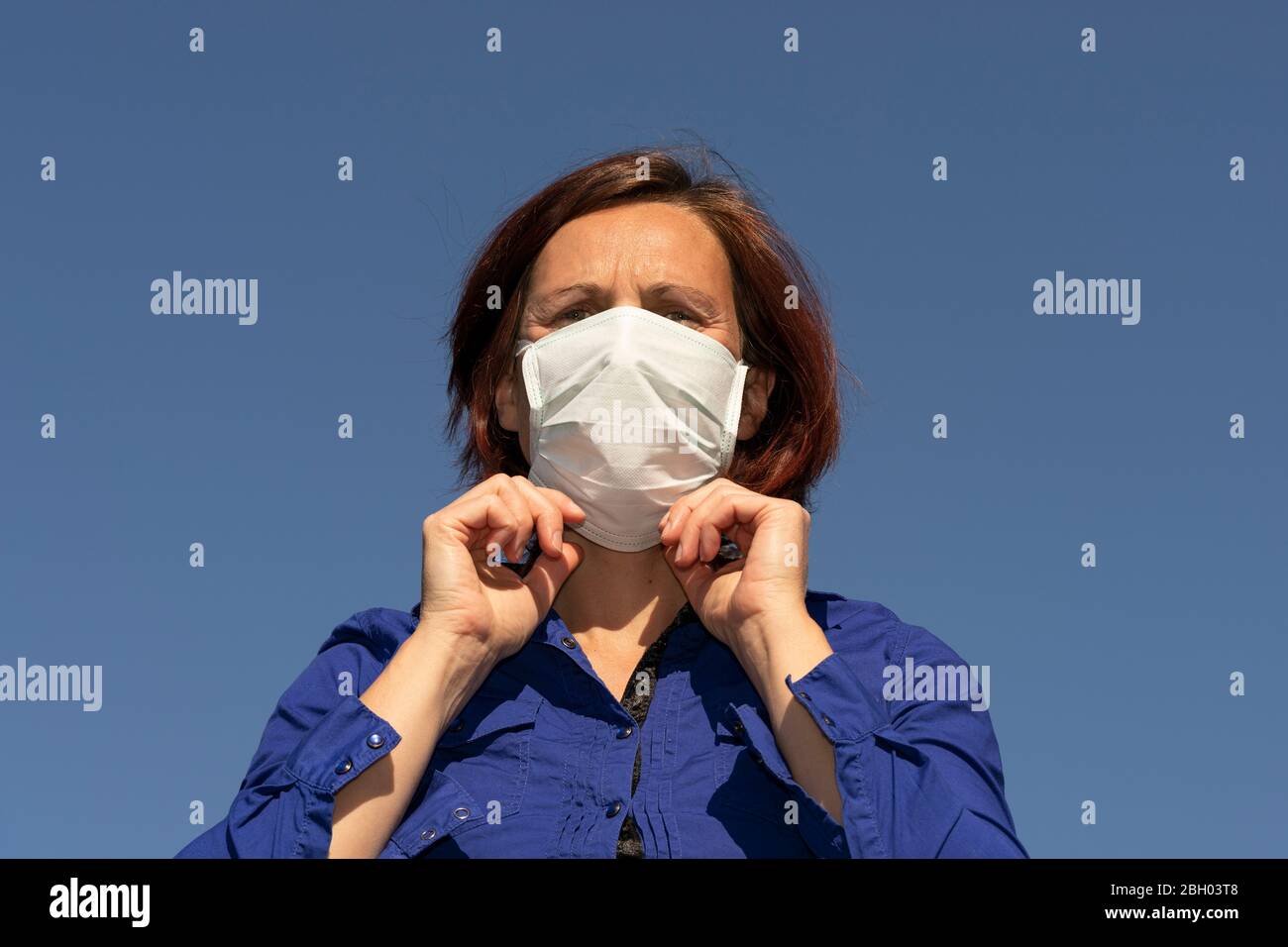 woman adjusting her mask outdoor Stock Photo - Alamy