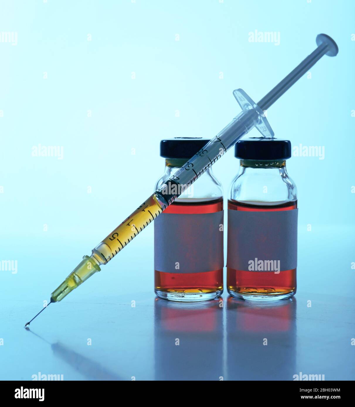 Medical ampule with syringe on blue background Stock Photo - Alamy