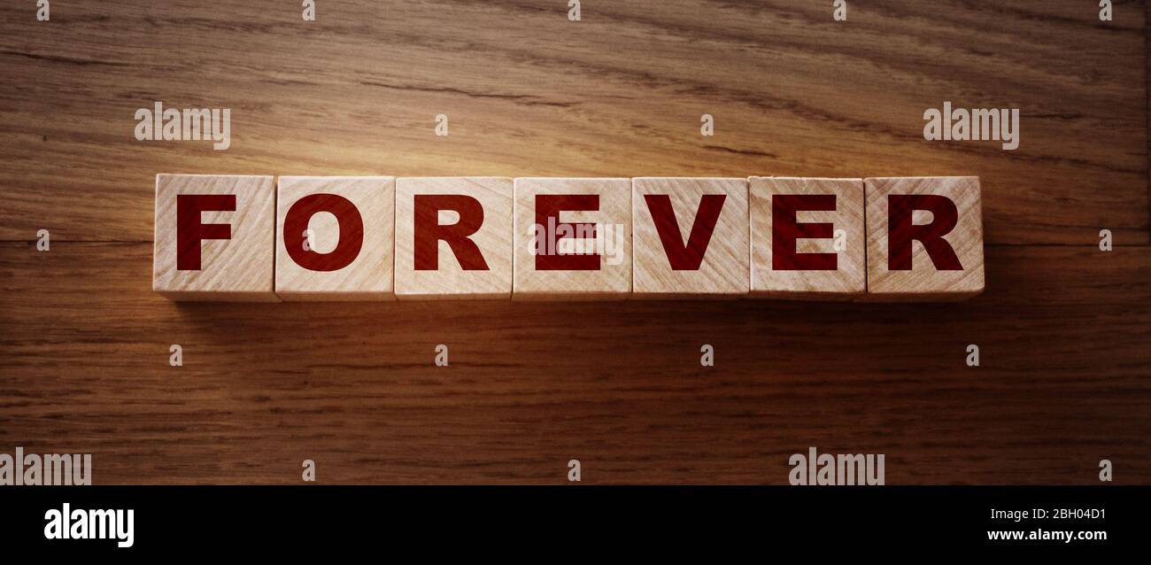 FOREVER word on wooden cubes on wooden Floor. Eternal love or ...