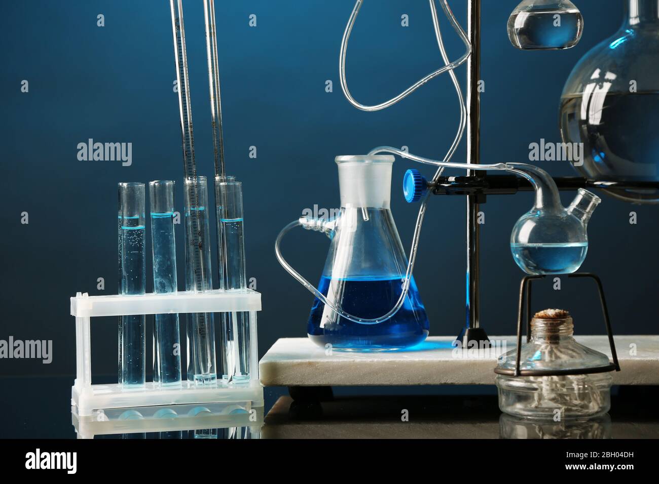 Fixed laboratory glassware on support on dark colorful background Stock ...