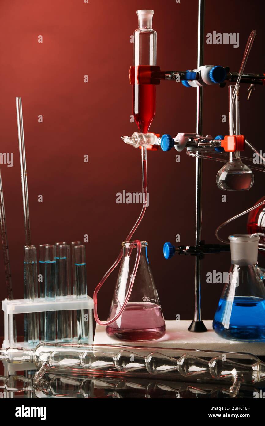 Fixed laboratory glassware on support on dark colorful background Stock ...