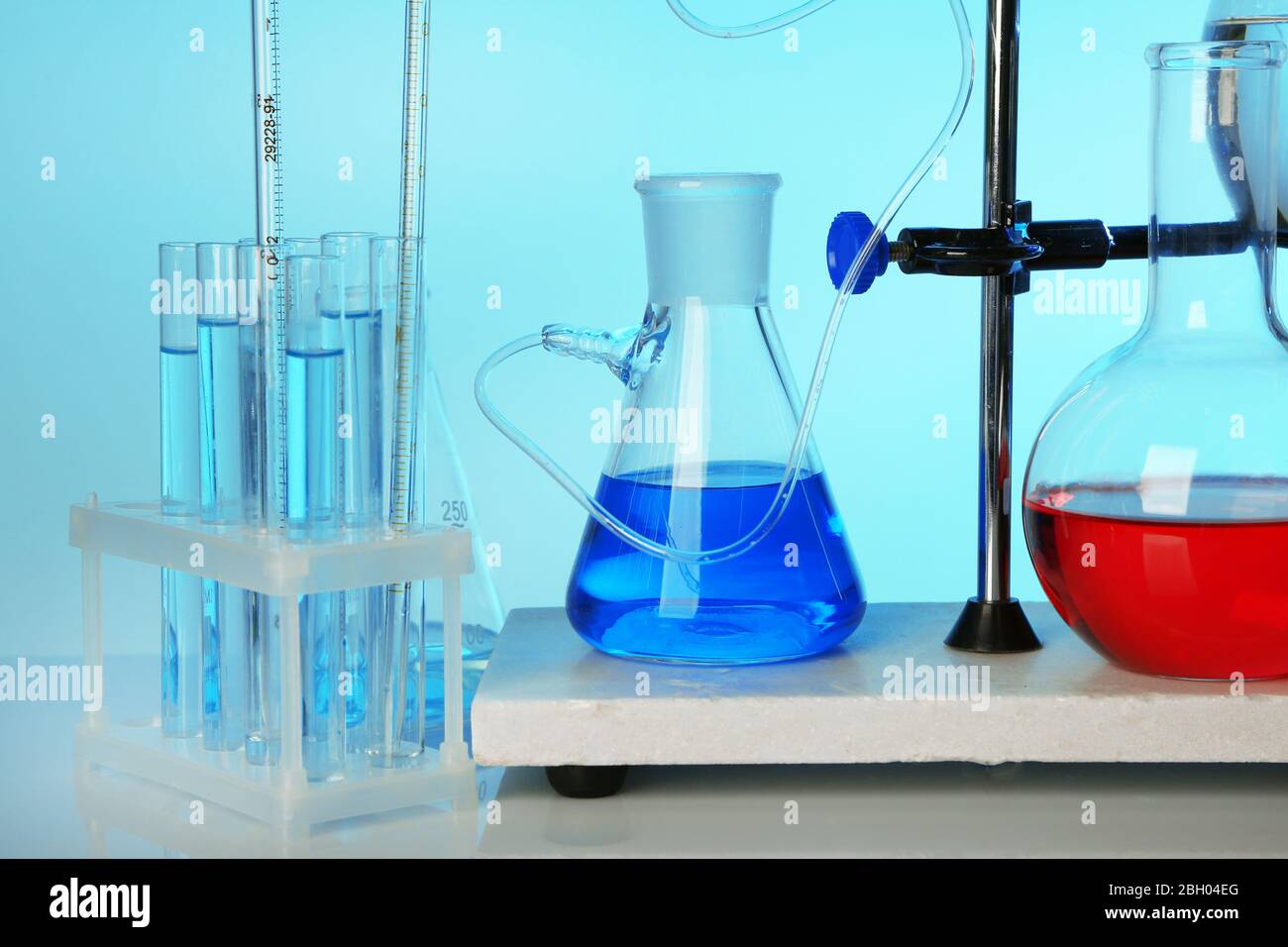 Fixed laboratory glassware on support on colorful background Stock ...