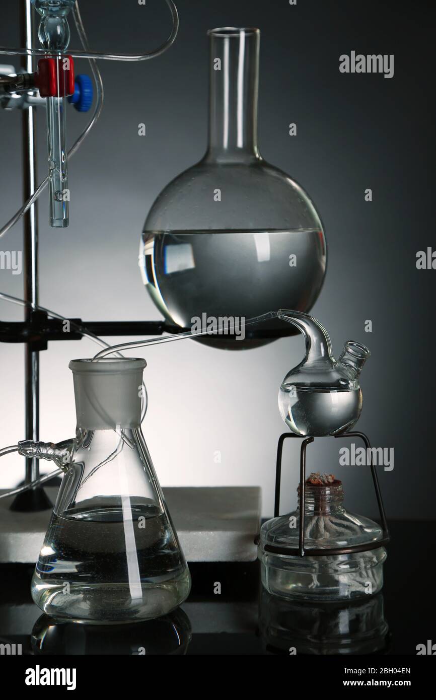 Fixed laboratory glassware on support on dark colorful background Stock ...