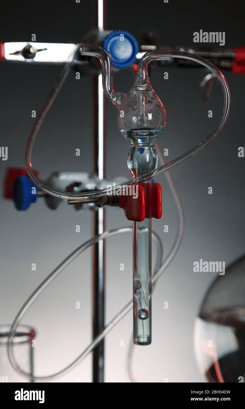Fixed laboratory glassware on support on dark colorful background Stock ...