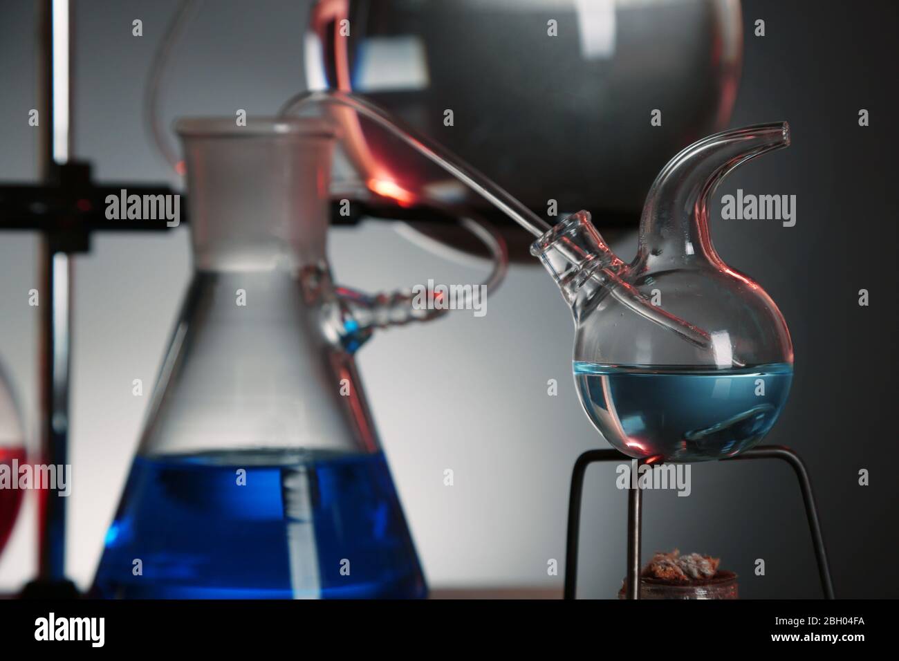 Fixed laboratory glassware on support on dark colorful background Stock ...