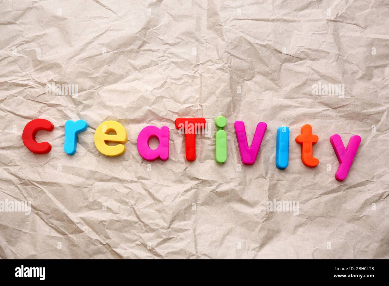 Creativity motto by alphabet letters on crumpled paper background Stock ...