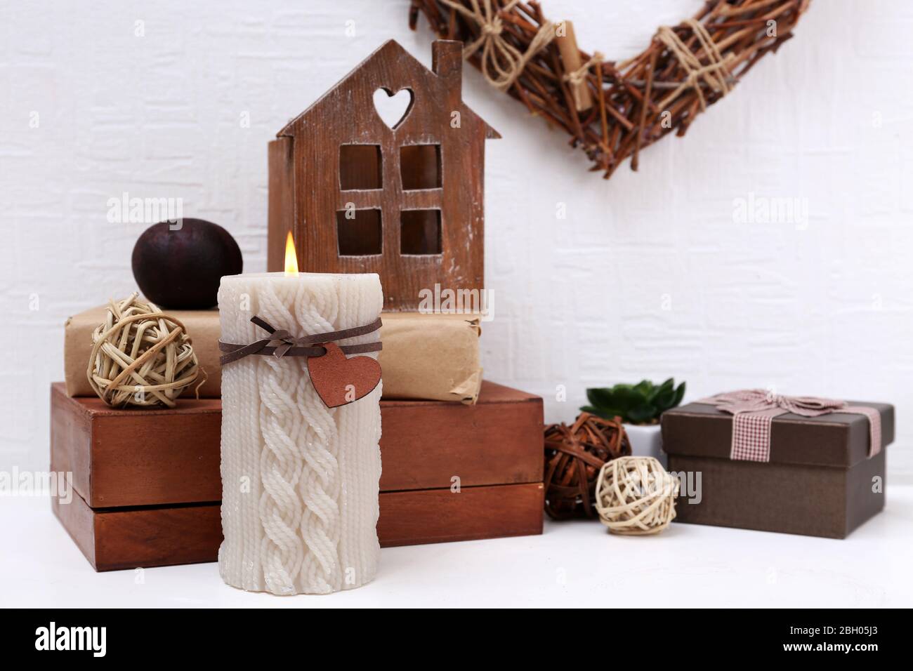 Romantic still life with wicker heart and design details on shelf and ...