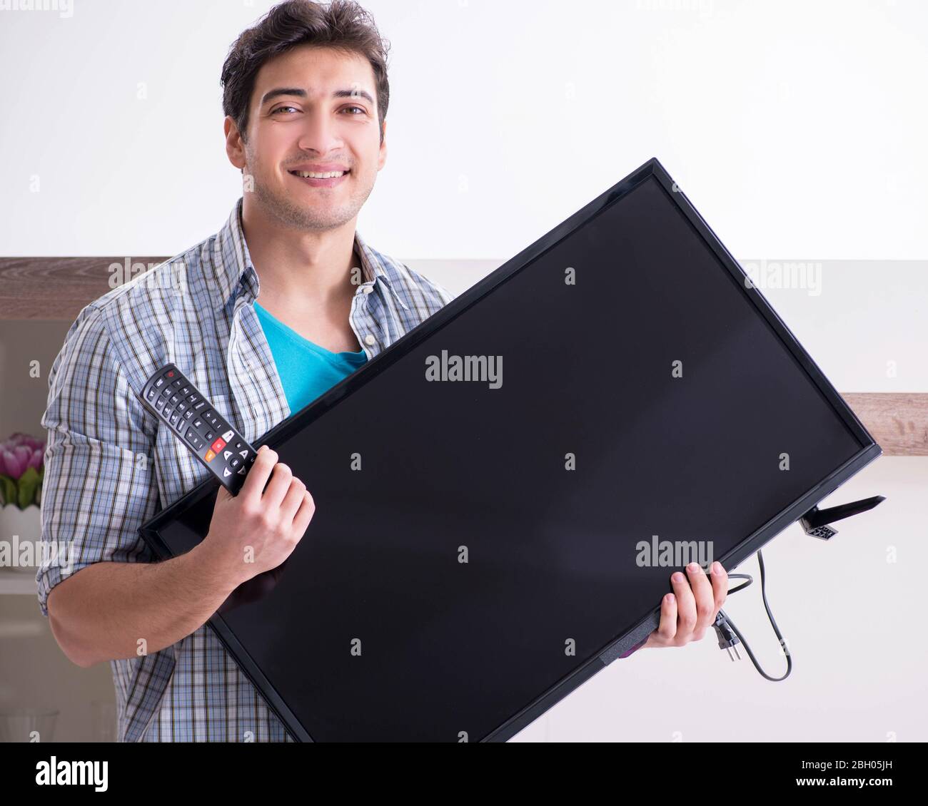 The man trying to fix broken tv Stock Photo - Alamy